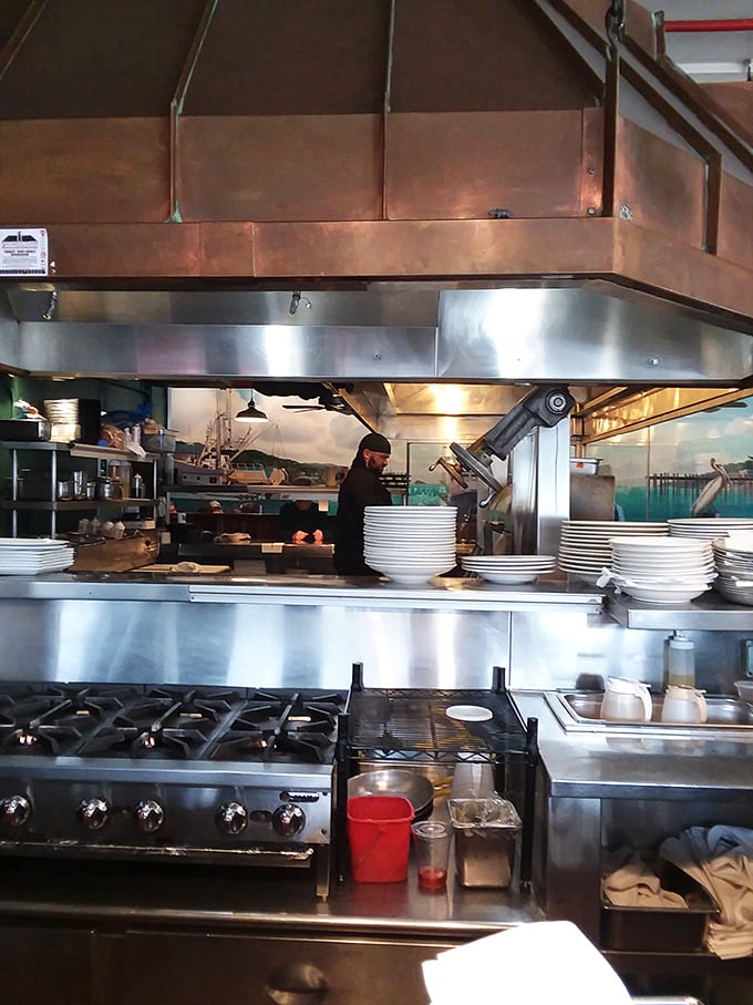 Where the culinary alchemy happens—gleaming stainless steel, copper hoods, and chefs who know exactly how long that artichoke needs on the oak grill.