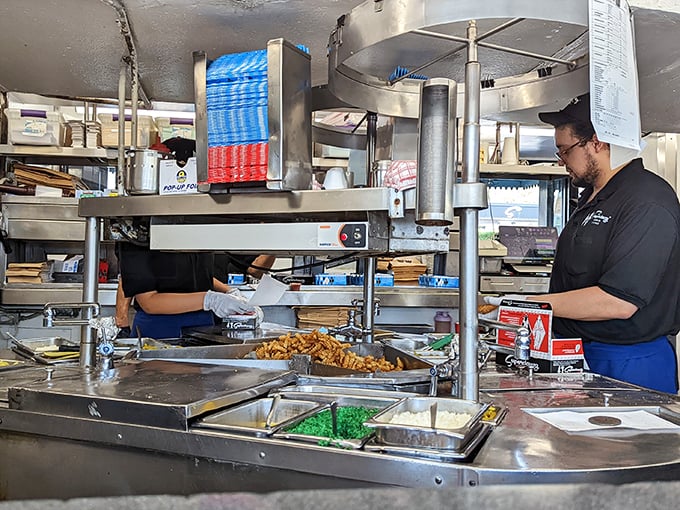 The kitchen reveals the organized chaos where Chicago's iconic hot dogs come to life—a symphony of condiments conducted with practiced precision. 