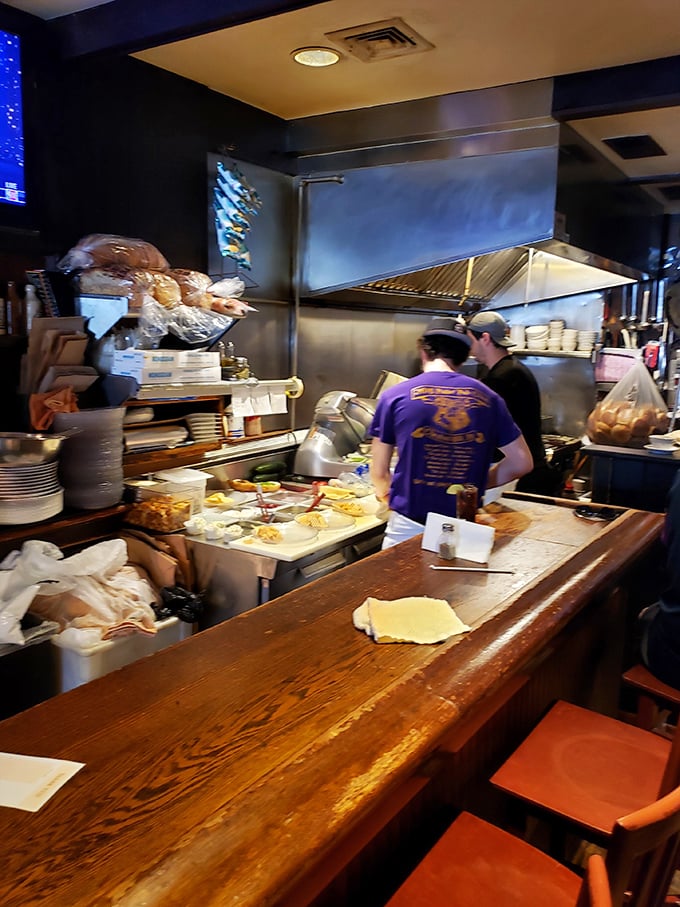 A glimpse into the kitchen reveals the organized chaos where culinary dreams become reality. No fancy equipment, just skilled hands and quality ingredients.