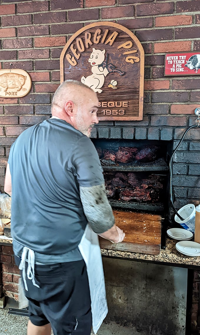 The open pit reveals the secret—real wood, real smoke, real patience. No shortcuts in sight, just craftsmanship you can taste.