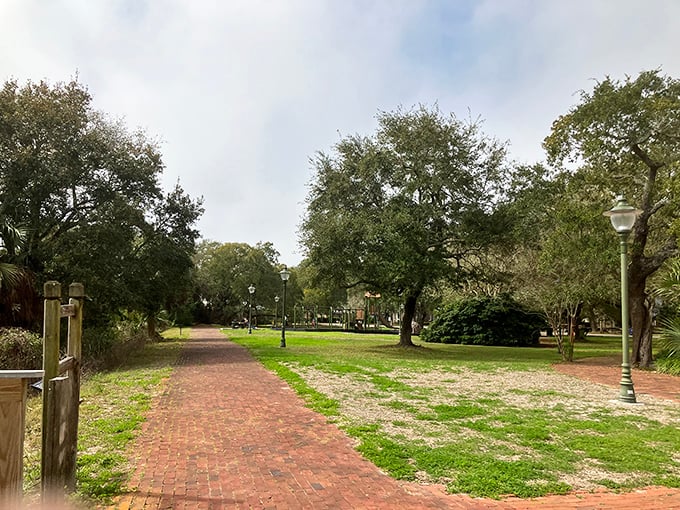 Lafayette Park's brick pathways meander beneath ancient oaks draped in Spanish moss – Mother Nature's version of mood lighting for an afternoon stroll.