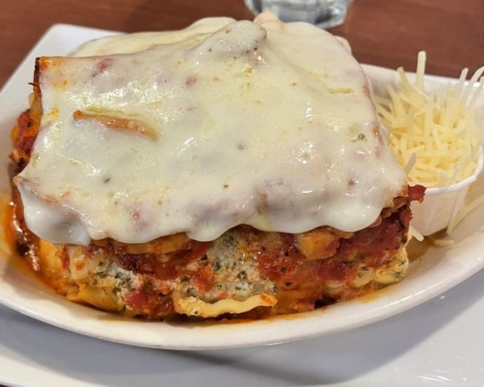 Lasagna that doesn't just sit on the plate—it commands respect with layers of cheese that stretch dramatically with each forkful.