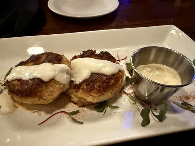 These aren't just crab cakes—they're seafood sculptures with minimal filler and maximum flavor, topped with a delicate sauce that would make Maryland natives nod in approval.
