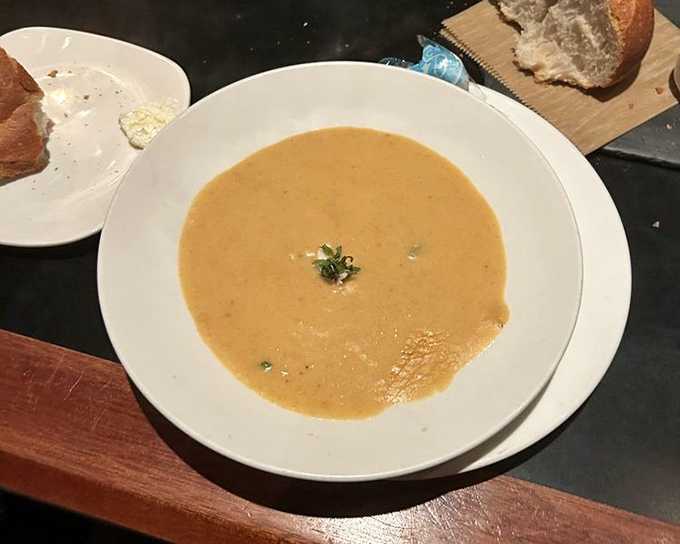This crab bisque doesn't whisper its seafood flavor – it announces it proudly with a velvety texture that coats your spoon just right.