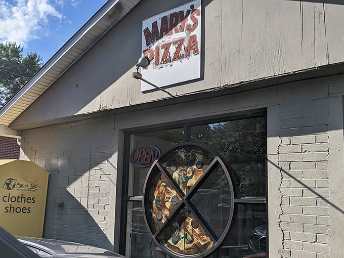 Mary's Pizza doesn't need fancy marketing—that slice-shaped window display says everything you need to know about their priorities. Simple, honest, delicious.