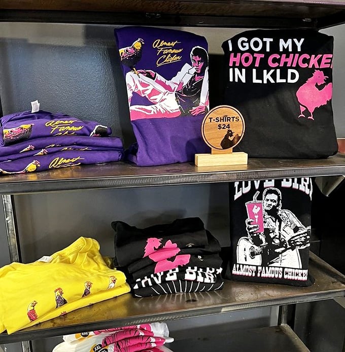 The merch wall proves LoveBird isn't just a restaurant but a lifestyle – with shirts declaring "I GOT MY HOT CHICKE IN LKLD" like badges of honor.