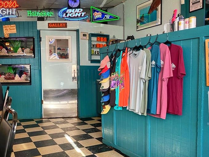 Keegan's merchandise wall – because sometimes you need a t-shirt to prove you've discovered one of Florida's seafood treasures.