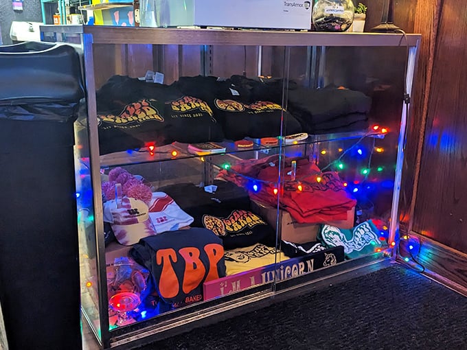 The merch display glows like a shrine to pizza culture—because wearing your food loyalty on your sleeve is always in fashion.