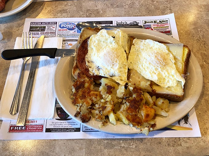 Breakfast that means business—two perfectly fried eggs atop toast with a mountain of home fries. The breakfast of champions who plan to nap later.