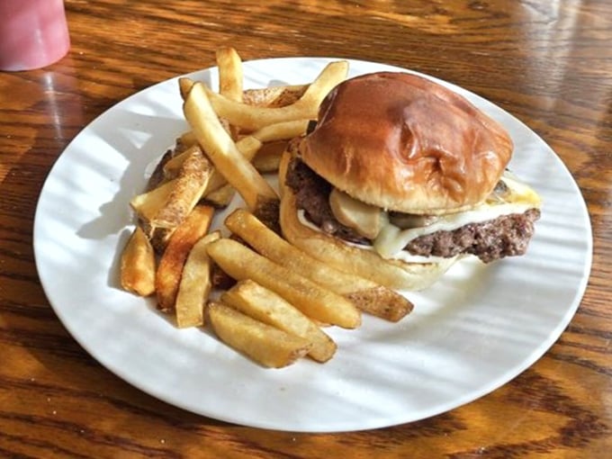 A burger that doesn't need fancy aioli or artisanal buns to impress—just honest beef, melted cheese, and fries that remind you of simpler times.