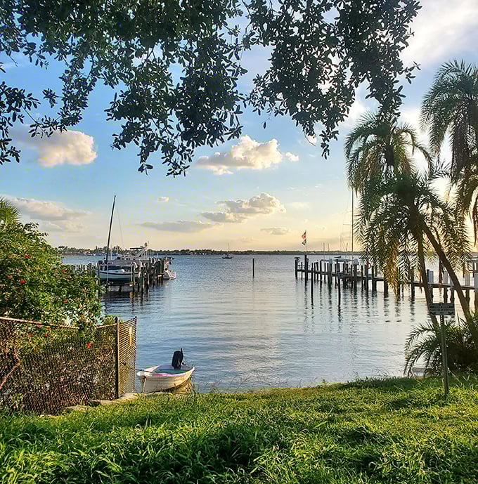 Waterfront views peek through tropical foliage, creating natural frames for moments that remind you why you endured decades of work to retire here.