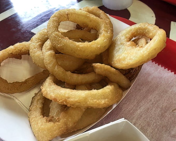 Onion rings with the perfect crunch-to-tenderness ratio – golden halos of happiness that make you wonder why anyone would settle for fries.
