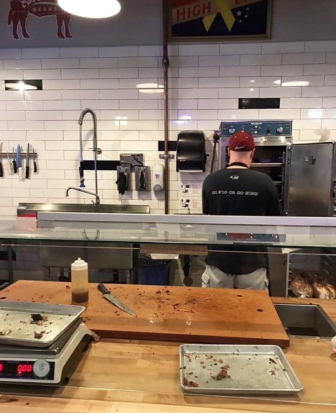 In the open kitchen, barbecue magic happens without smoke and mirrors – just smoke, skill, and a t-shirt that speaks the truth.