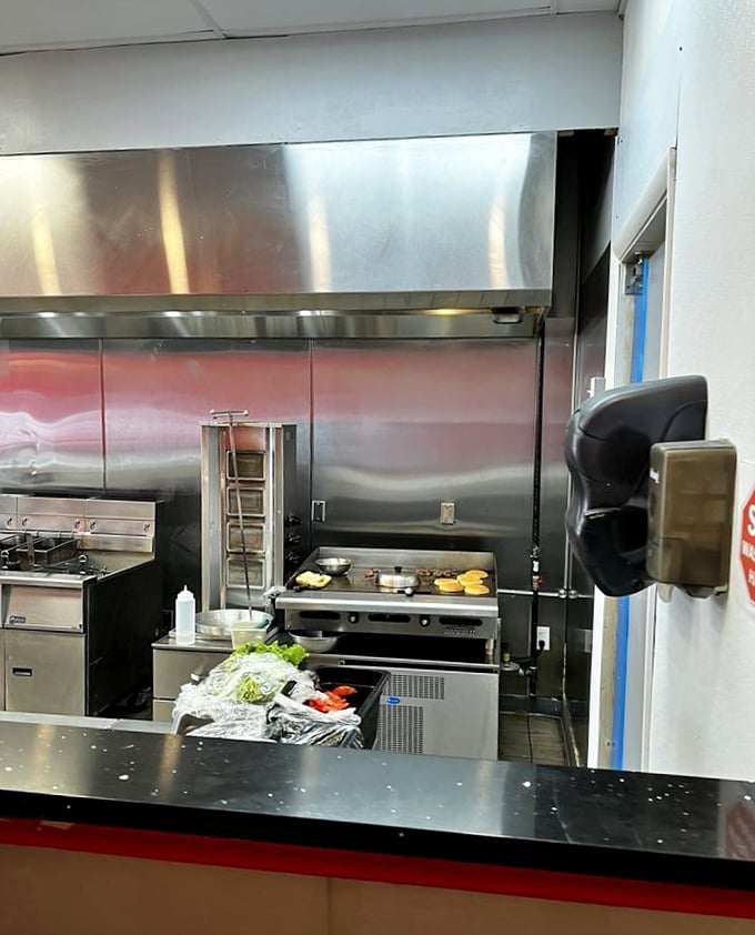 Where the magic happens—spotless stainless steel and fresh ingredients waiting to become memories. Kitchen choreography at its finest.
