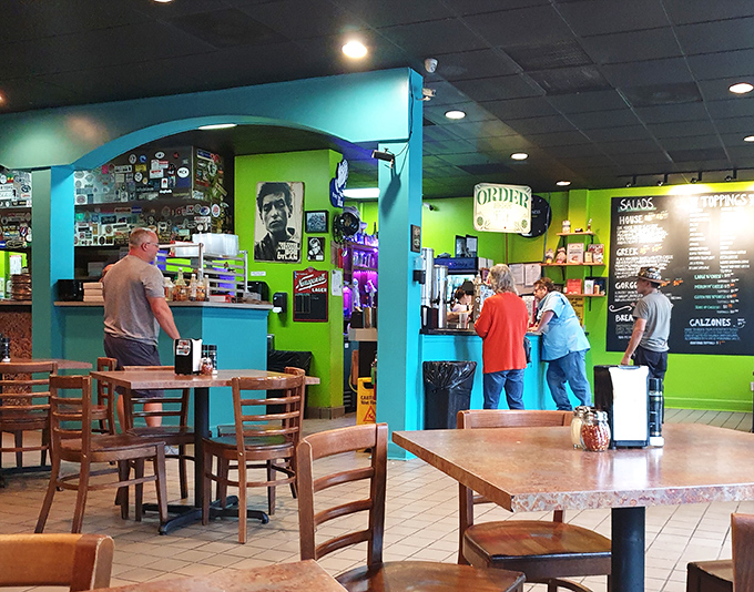 The ordering counter—where pizza dreams begin their journey to reality. The colorful walls make even waiting a visual feast.