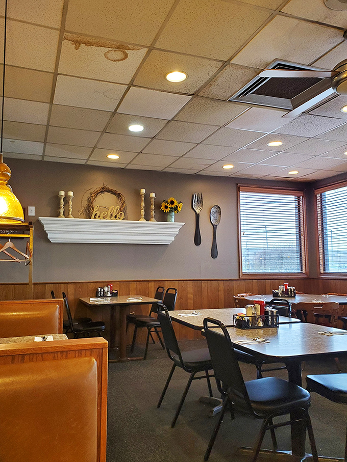 Cozy corners and oversized utensil decor create that "grandma's kitchen meets professional diner" vibe that somehow makes everything taste even better.