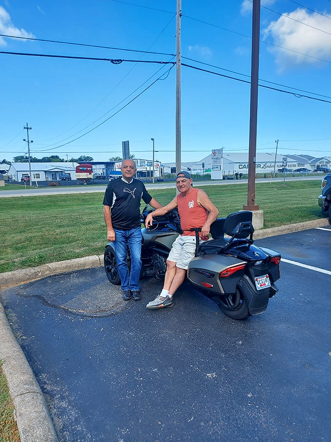 Even the parking area offers a glimpse of Lake Erie life, where motorcycles and conversations are part of the Harbor Light experience.