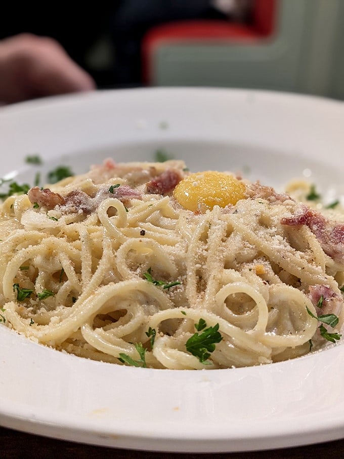 Carbonara that whispers "I'm worth every calorie." That egg yolk isn't just an ingredient—it's the golden ticket to pasta perfection.