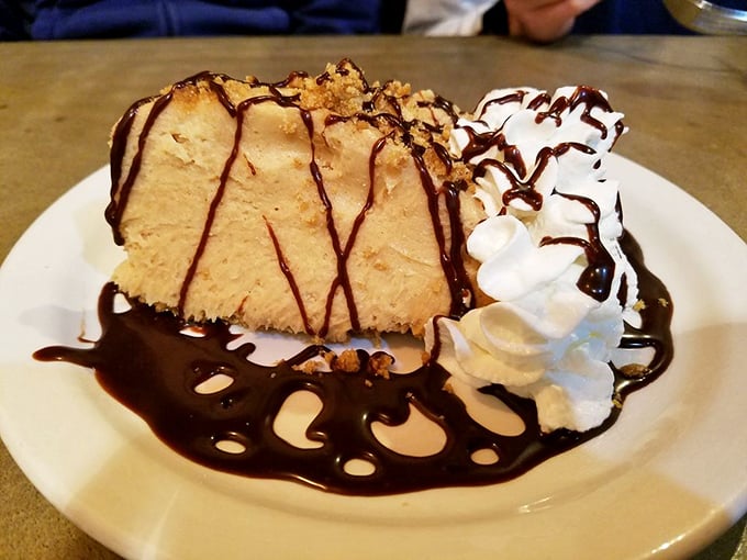 Peanut butter pie drizzled with chocolate that doesn't just end your meal – it makes you question why you wasted time on the main course.