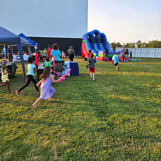 Pre-show entertainment includes inflatable fun, turning movie night into a full evening of family memories.
