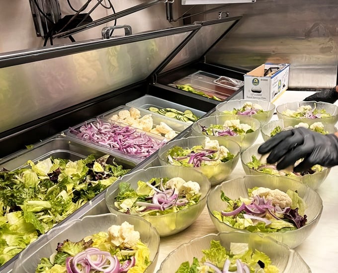 Fresh salad preparation is serious business – the opening act must be worthy of the headlining steaks that follow in this culinary concert.
