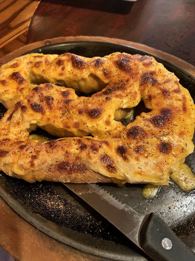 This pretzel isn't messing around—golden, twisted perfection topped with cheese that's been melted with what can only be described as profound respect.