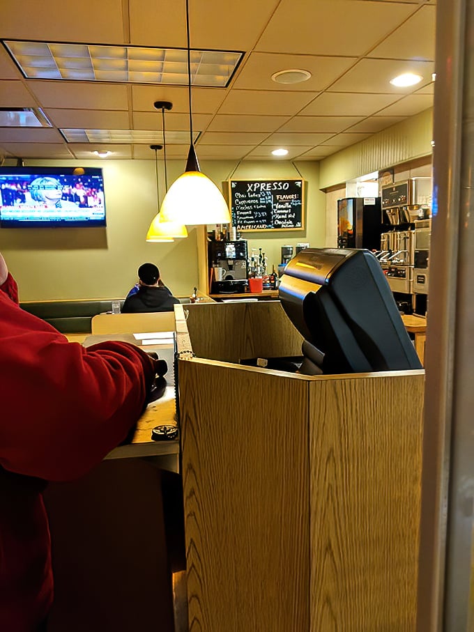 The heart of the operation—where orders fly and breakfast dreams materialize. That pendant lighting casts a golden glow on morning possibilities.