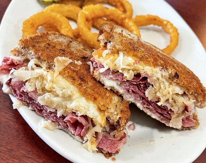 The Reuben that launched a thousand cravings, with sauerkraut and corned beef in perfect harmony. Those onion rings aren't just sides—they're supporting actors deserving their own award.