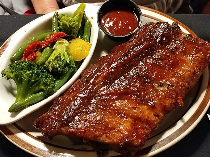 These ribs don't just fall off the bone—they practically leap onto your fork, trailing a wake of tangy sauce and smoky perfection.
