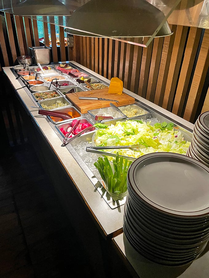 The salad bar—that endangered dining institution—survives gloriously here, with crisp vegetables standing at attention like delicious soldiers.