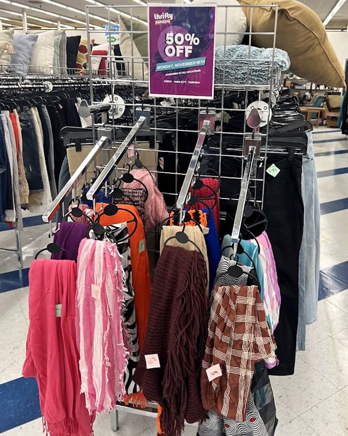 Scarf central! These colorful accessories hang like festive banners, each one waiting to become the perfect finishing touch to someone's outfit.