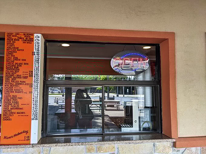 The reflection in the order window offers a glimpse of the promised land – where hungry patrons become satisfied customers in just minutes.