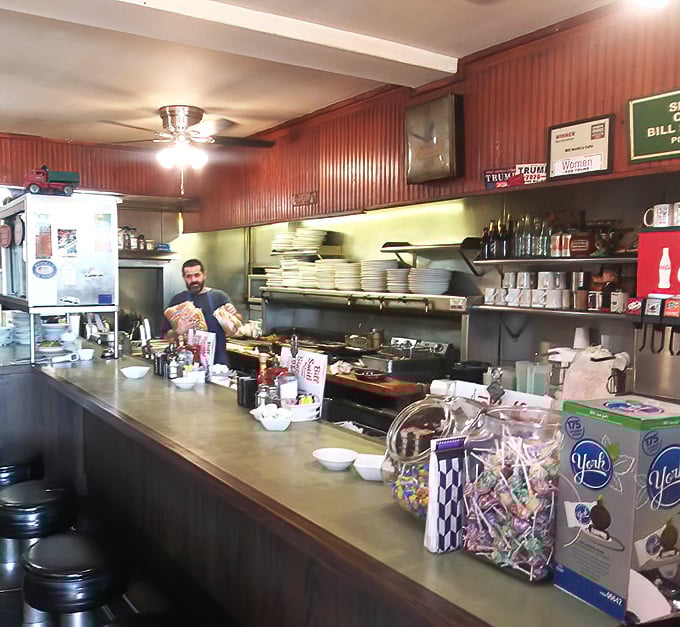 The counter view reveals the organized chaos that powers breakfast excellence—stacks of plates ready for the next round of hungry Texans.