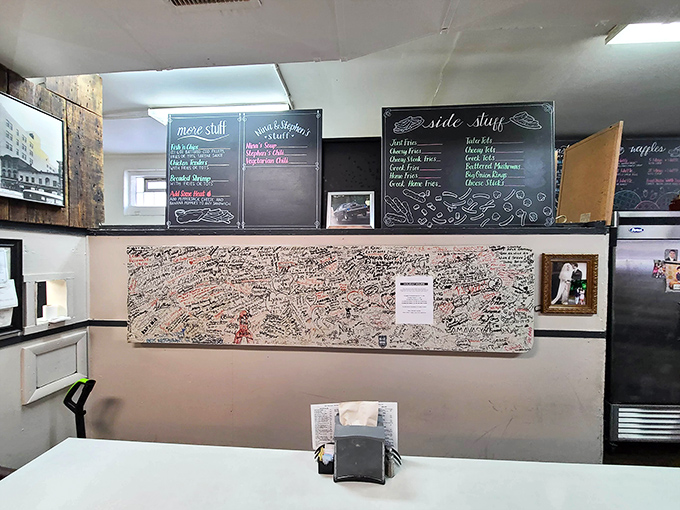 The wall of customer signatures tells the real story—this isn't just a restaurant, it's a community landmark where memories are made between bites.