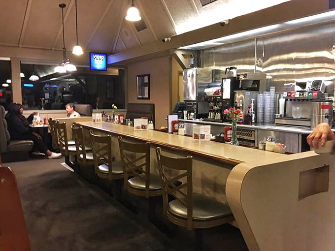 Counter seating at dusk—where solo diners find community, coffee cups are never empty, and servers know your order before you sit down.