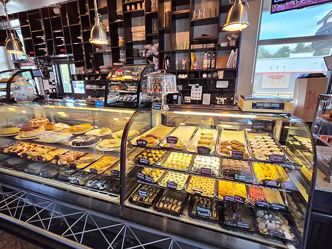 The bakery case—a glass-enclosed museum of carbohydrate masterpieces that makes choosing dessert beautifully impossible.