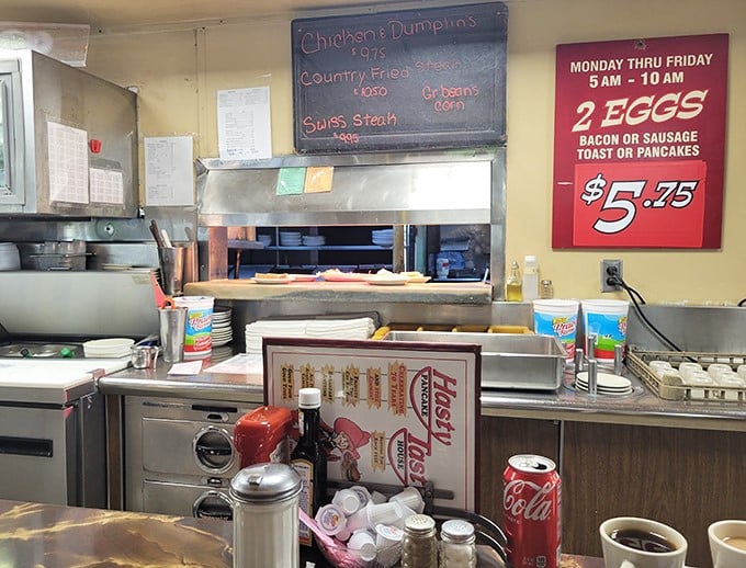 The kitchen pass—where breakfast dreams materialize under the watchful eyes of cooks who've flipped more eggs than most people have had hot meals.
