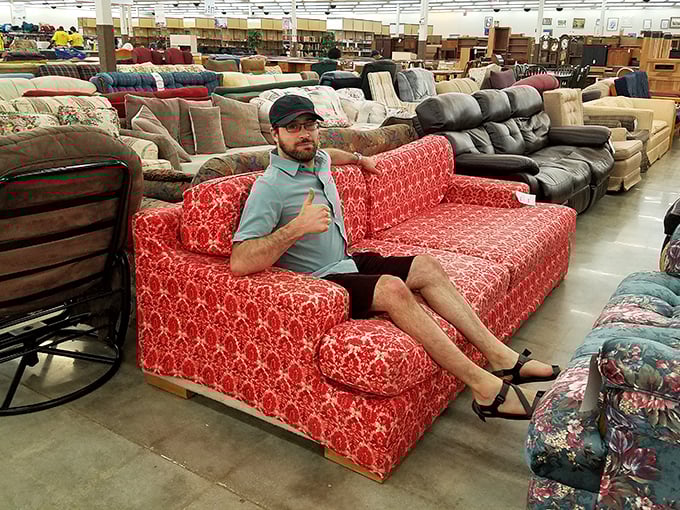 The universal thrift store victory pose: finding the perfect piece and immediately claiming it as your own. This red patterned sectional clearly sparked joy.