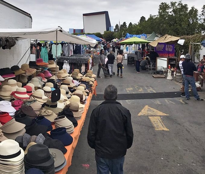 The market's main drag buzzes with weekend warriors on the hunt for that perfect something they didn't know they needed until now.
