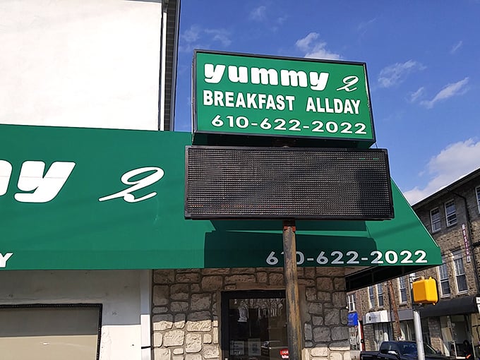 The sign glows like a green lighthouse, guiding hungry travelers through the treacherous seas of morning hunger.