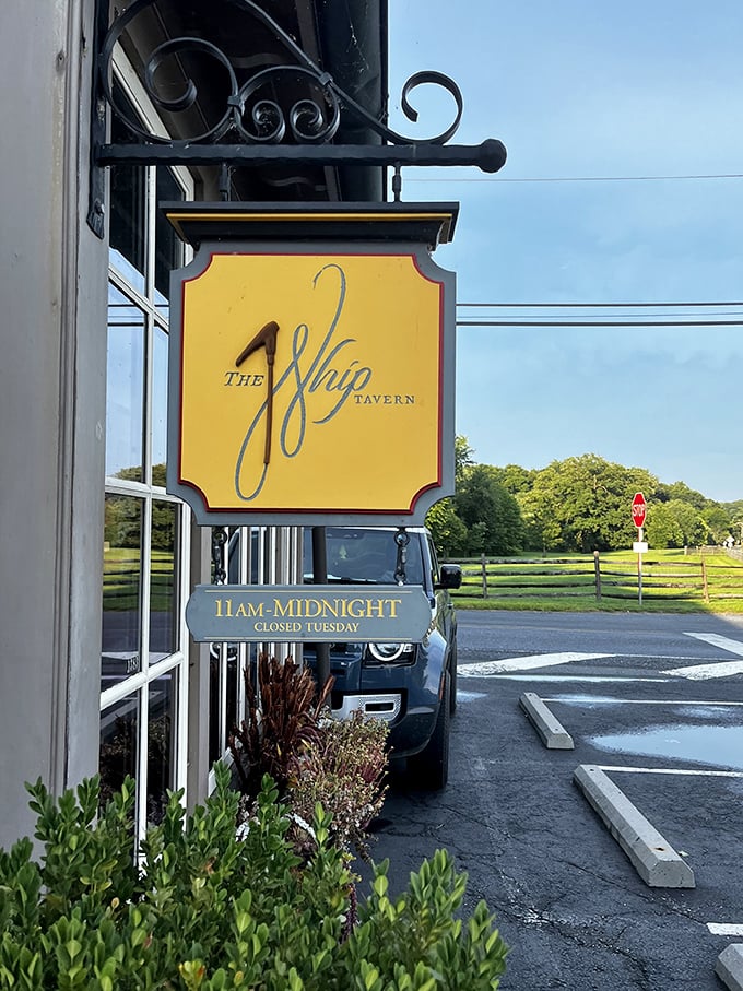 The signature yellow sign beckons like a lighthouse for the hungry. Note the hours – closed Tuesdays, because even perfection needs a day off.