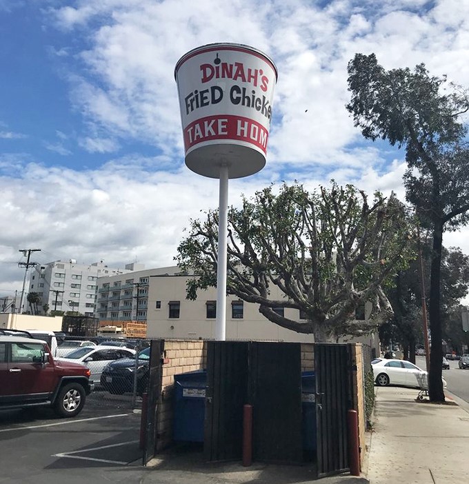 The giant chicken bucket sign stands tall against the California sky—a landmark that's guided hungry travelers for generations.