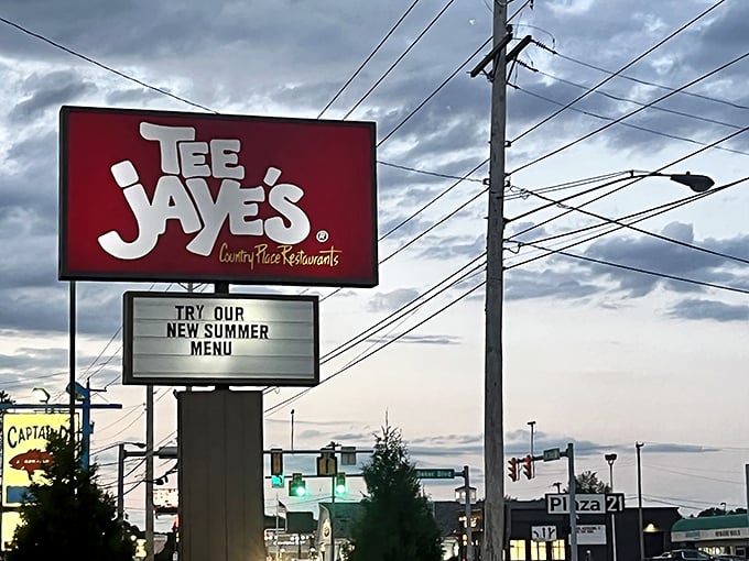 The red Tee Jaye's sign stands tall against cloudy skies, a beacon of hope for the hungry traveler. Breakfast salvation awaits.
