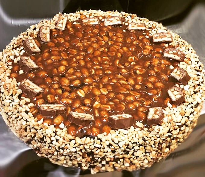 This Snickers cheesecake isn't just dessert – it's architecture. The kind of sweet engineering that makes you question why you ever wasted stomach space on vegetables.
