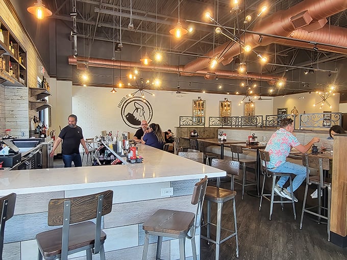 Where breakfast professionals work their morning magic. That copper ductwork overhead isn't just functional—it's part of the warm ambiance.