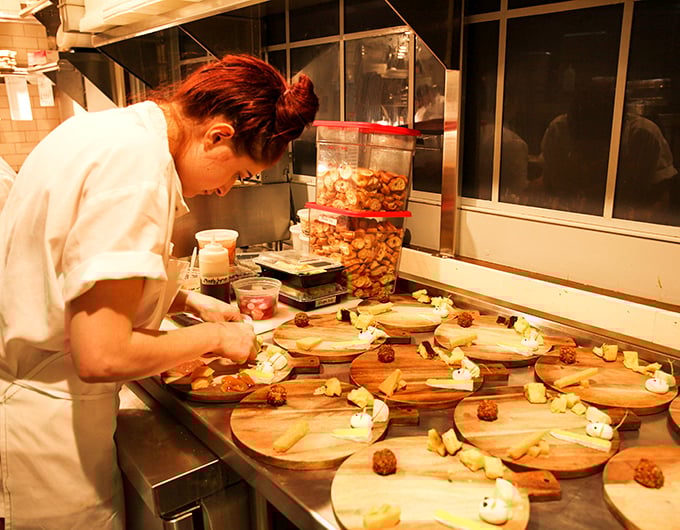 Behind the scenes, culinary magic happens with focused precision – each plate assembled with care that you can taste in every bite.