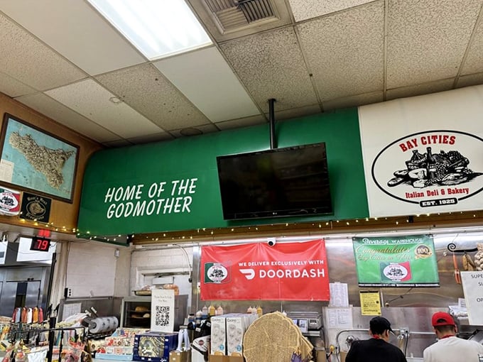 The sign proudly declares "HOME OF THE GODMOTHER" for good reason. It's not just a sandwich—it's a Santa Monica institution.