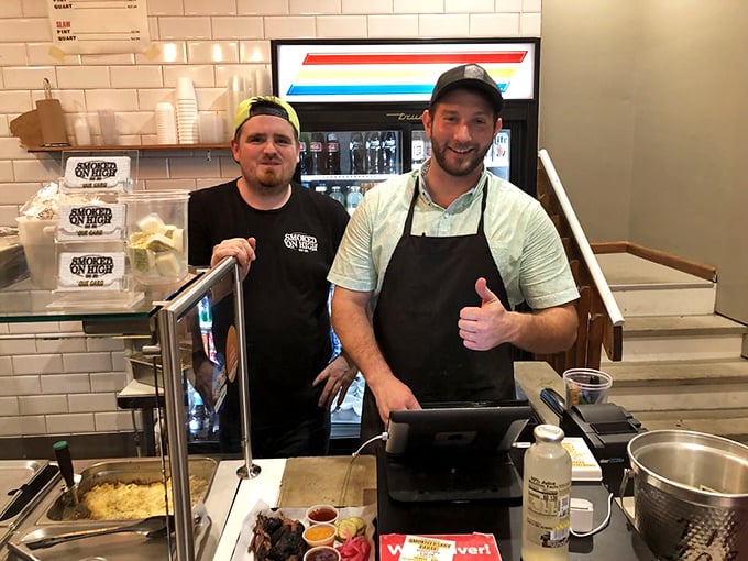 The folks behind the counter aren't just staff—they're the keepers of smoke secrets and the reason your clothes will smell delicious later.