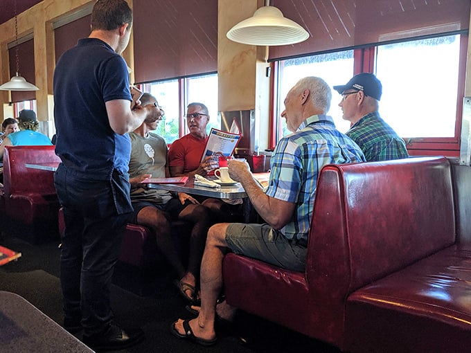 The dance of dining: attentive servers taking orders while customers debate the eternal question—sweet or savory?