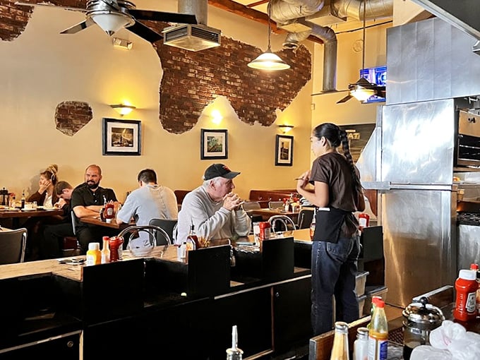 The servers here don't just bring food—they deliver experiences. That knowing smile says, "Yes, you'll need a box for the leftovers."